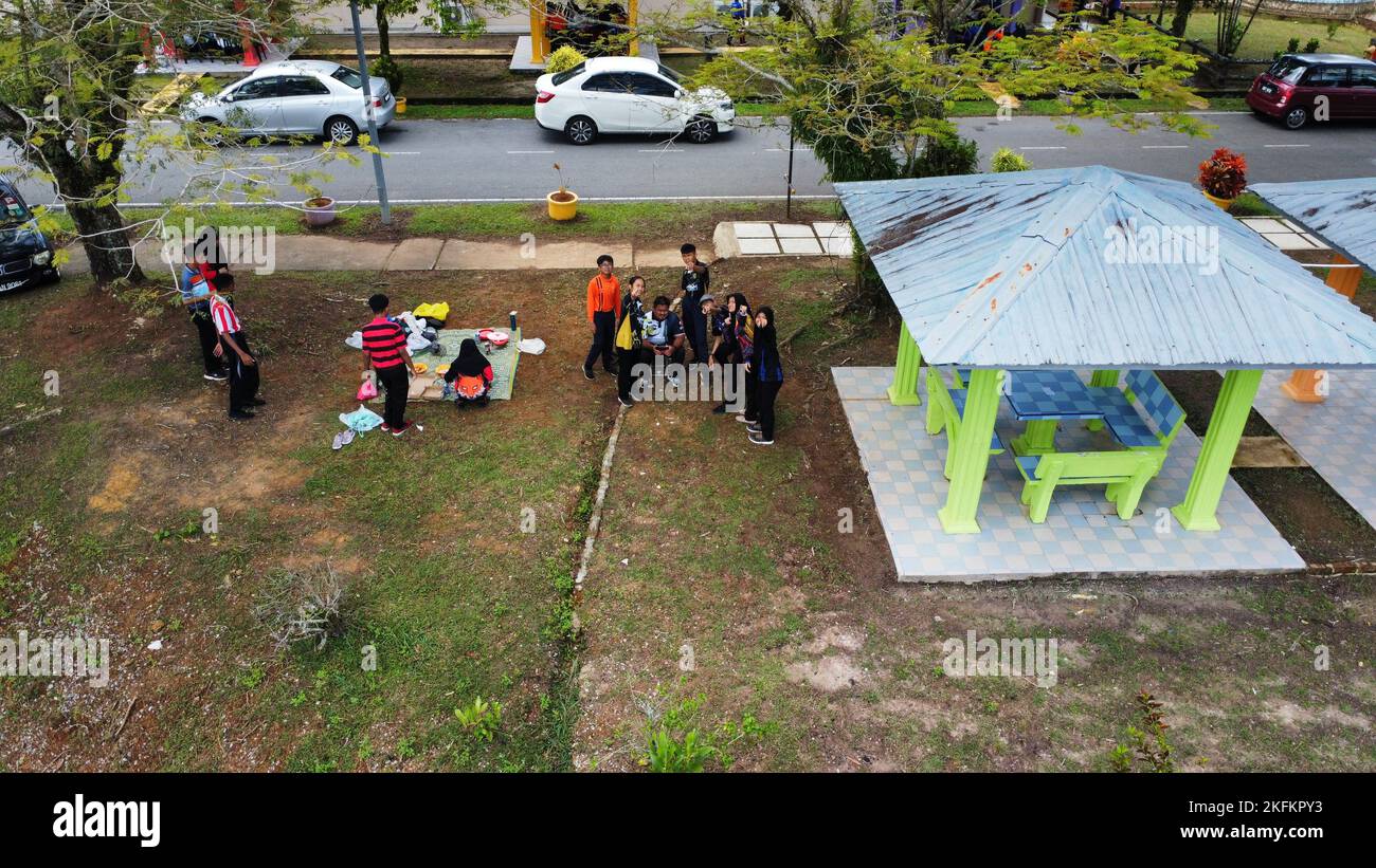 An aerial of a field of MRSM Kuching Sarawak with trees and people ...