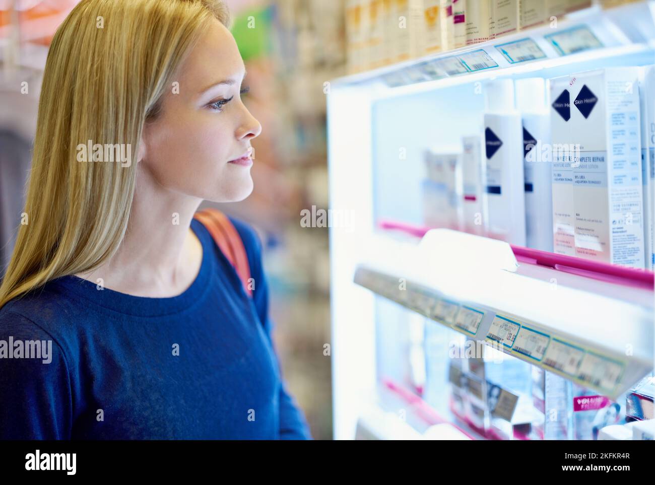 Theres so many options nowadays. a young woman browsing the shelves in ...