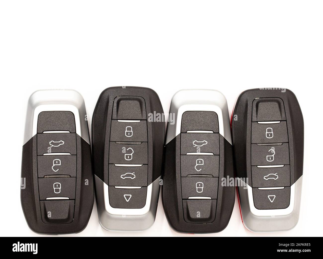 Car keys lie in different poses on a white background. Black and red ...