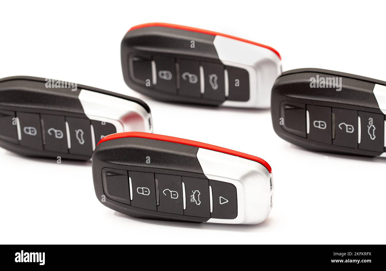 Car keys lie in different poses on a white background. Black and red ...
