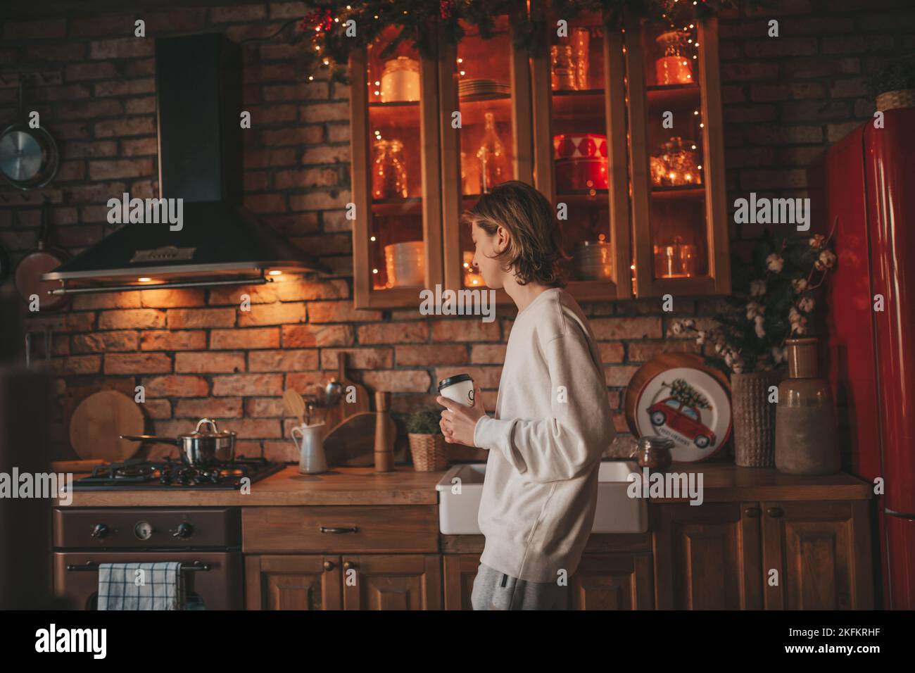 Young teenage boy with long hair in morning routine and preparing on ...