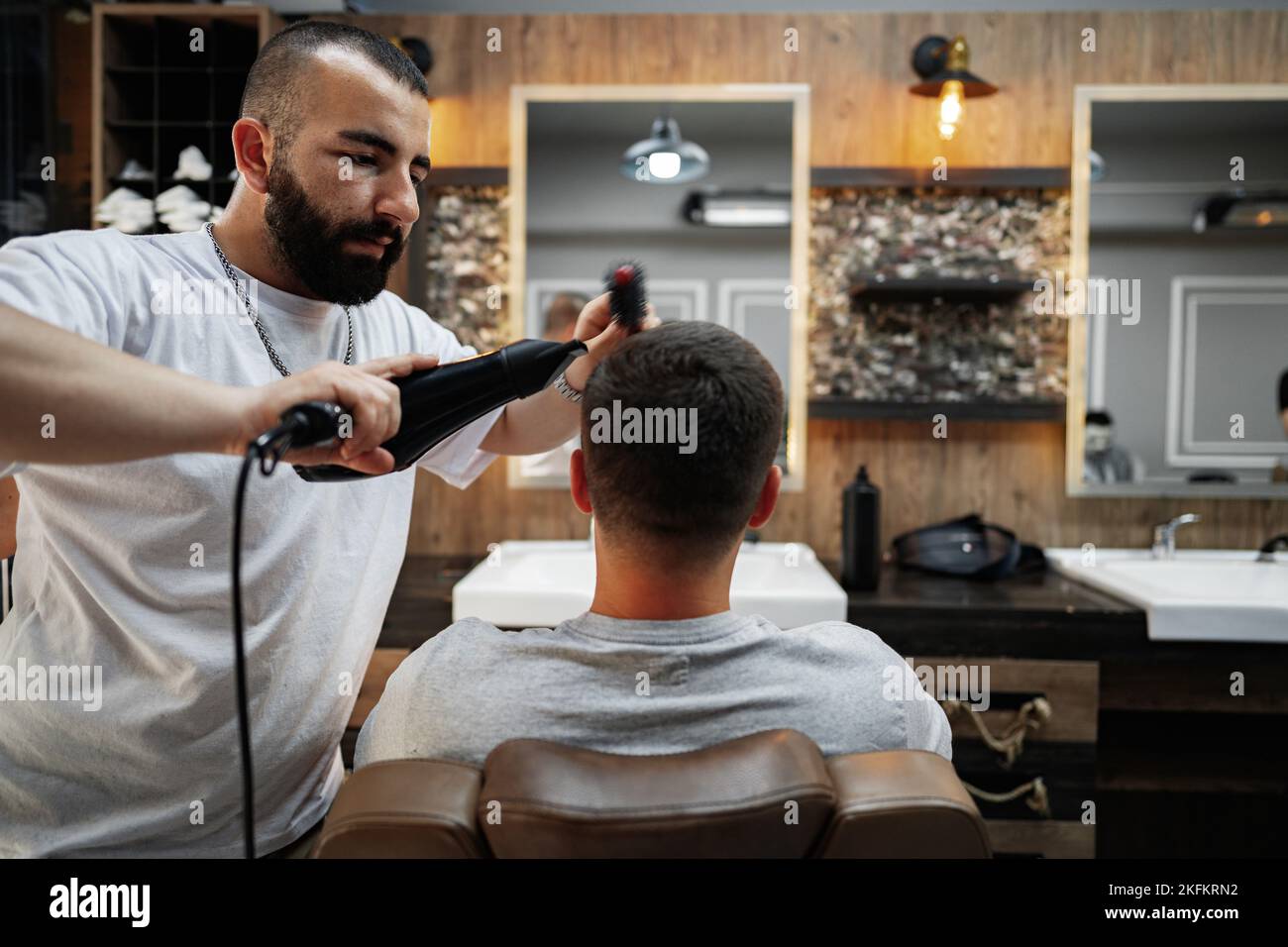 ISTANBUL, TURKEY - MAY 16, 2022: Hairstylist doing haircut for client ...