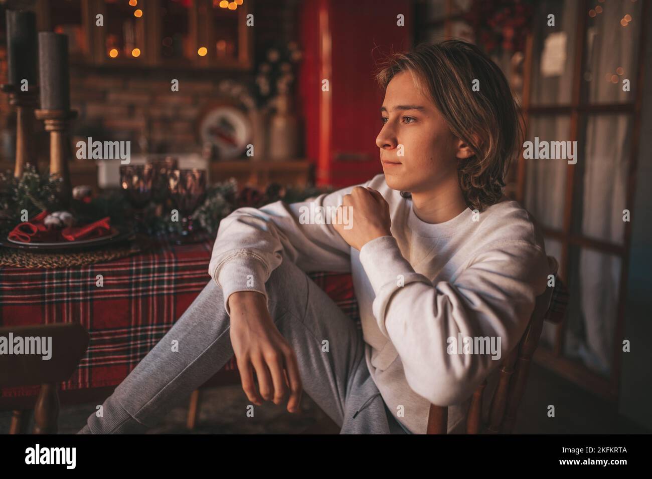 Young emotional cheerful teen boy with long hair laughter and joyful at ...