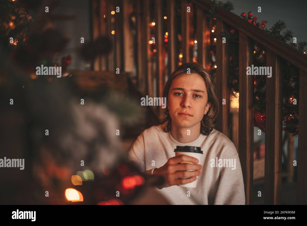 Young teen boy with long hair thoughtful look sad eyes negative mood ...