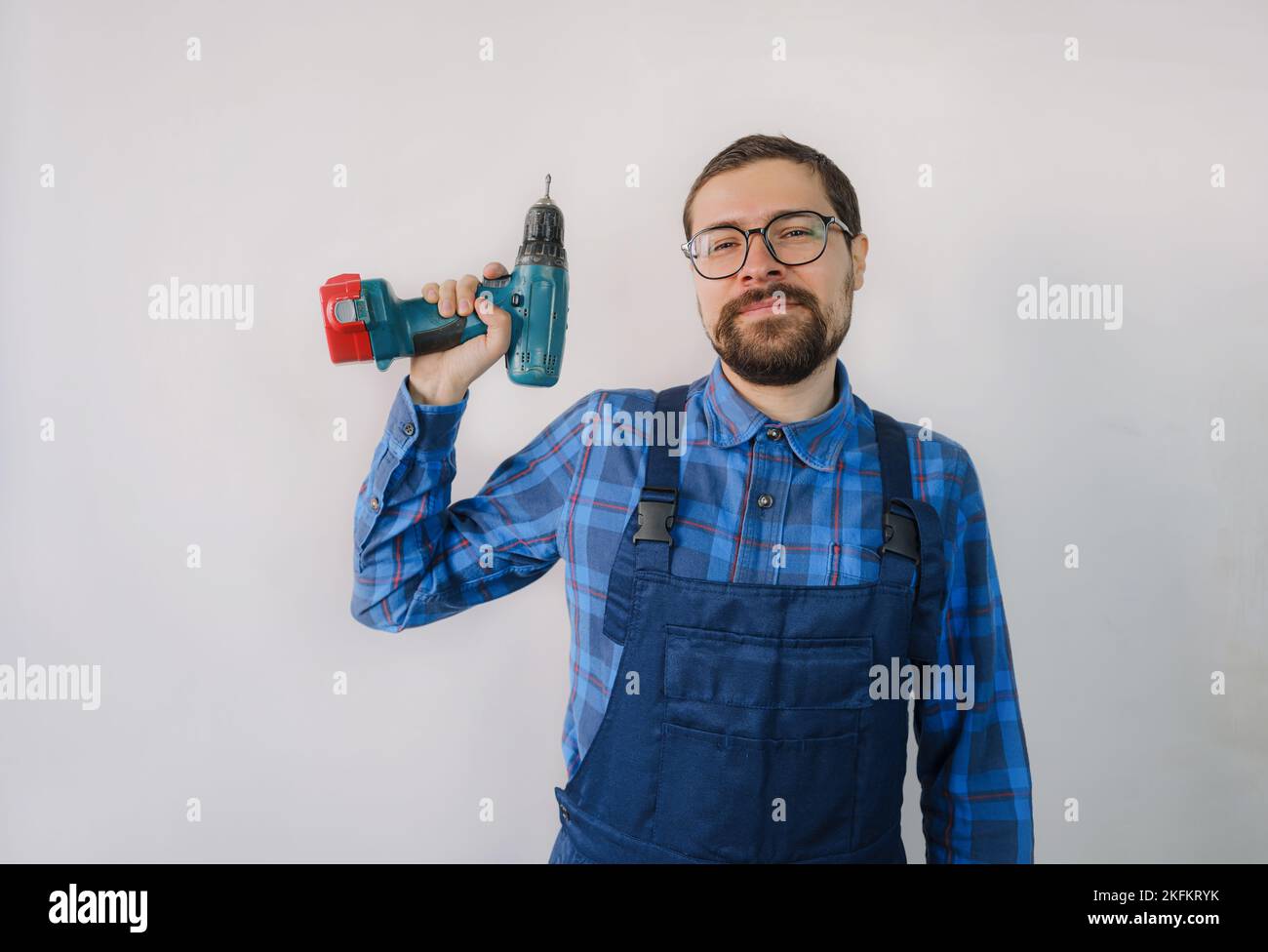 young man in blue work suit doing Repair apartment. Home renovation ...