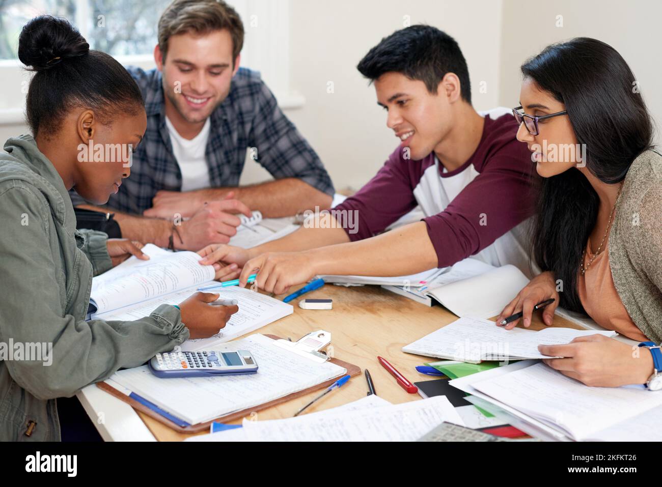 Working on their project. a group of university students in a study ...