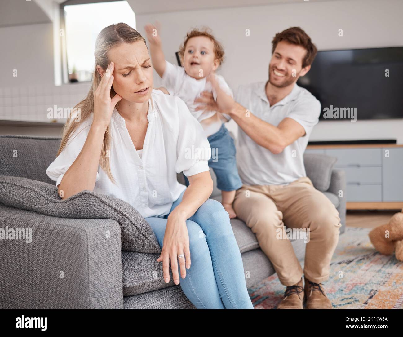 Family, stress and headache of mother on sofa with father, hyper active energy and adhd child ...