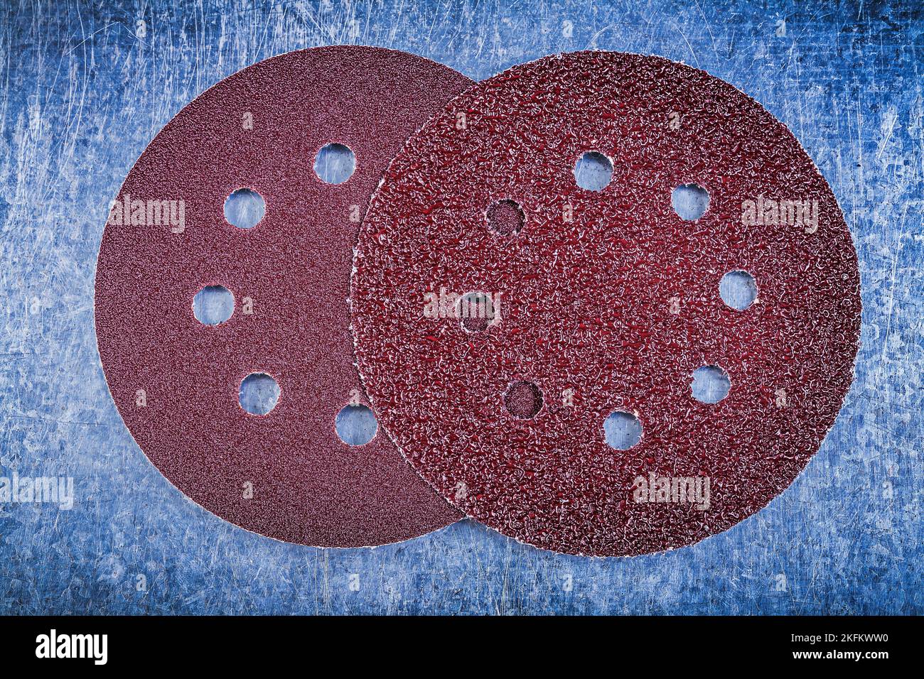 Abrasive discs on scratched metallic background Stock Photo - Alamy