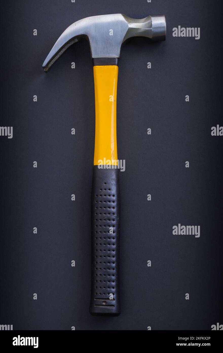 aerial view claw hammer with yellow and rubber handle on black ...