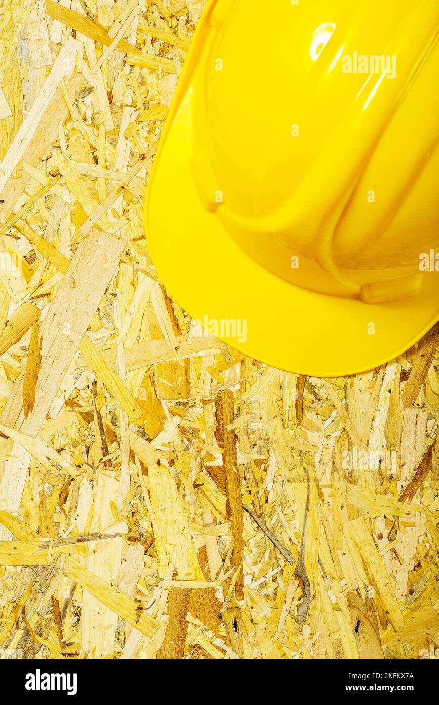an yellow helmet on plywood Stock Photo - Alamy
