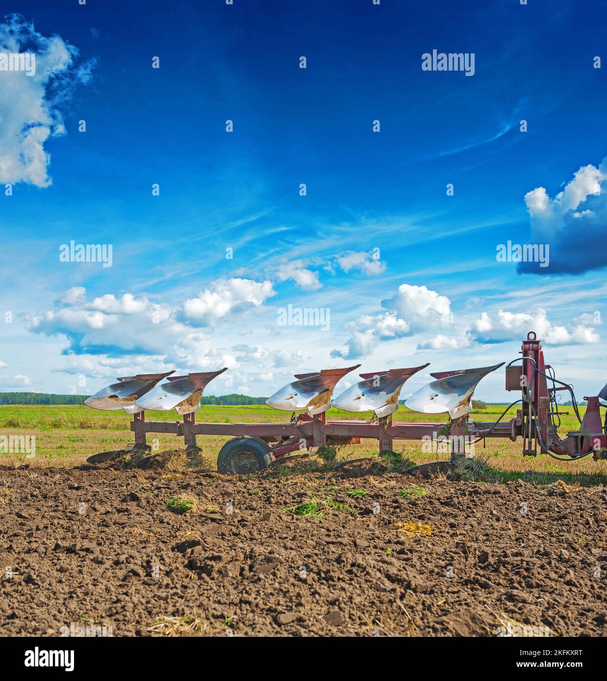 big plough in work on field at spring agricultural concept Stock Photo ...