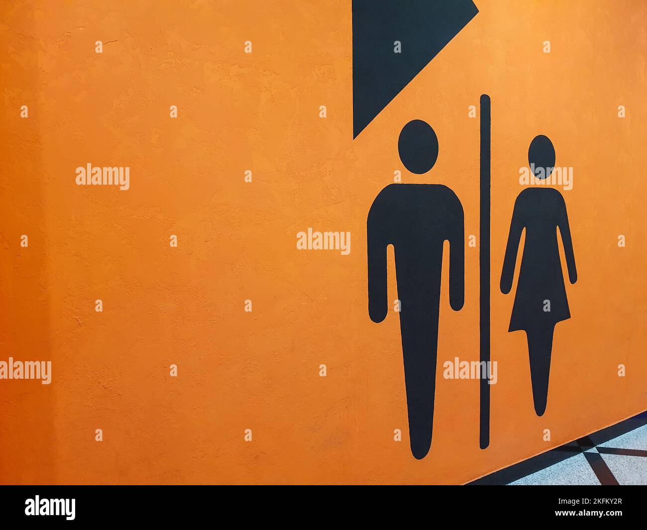 Toilet wc restroom sign man and woman icon graphic on orange wall Stock ...