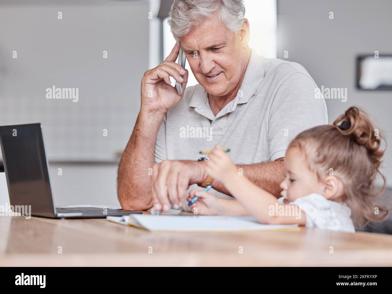 Phone call, senior man and girl at a table, working, remote and ...