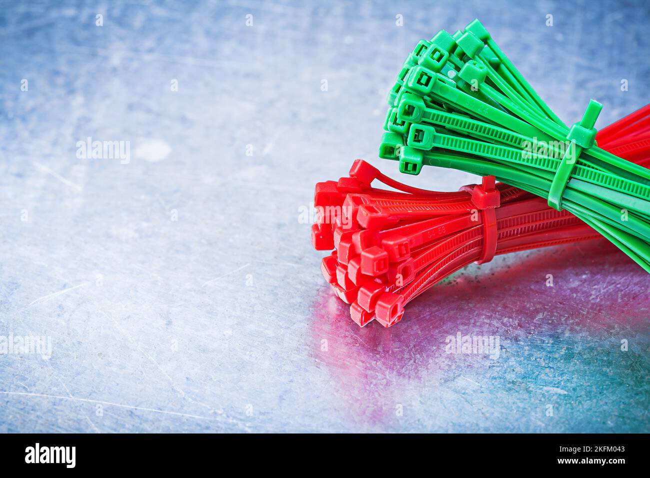 Bundle of self-locking cable ties on metallic background construction ...