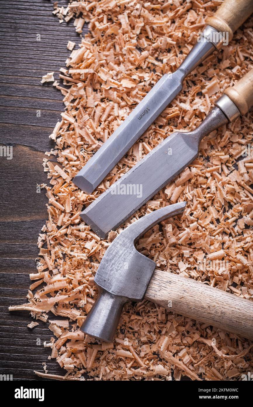 Claw hammer firmer chisels and wooden scobs on vintage wood board ...