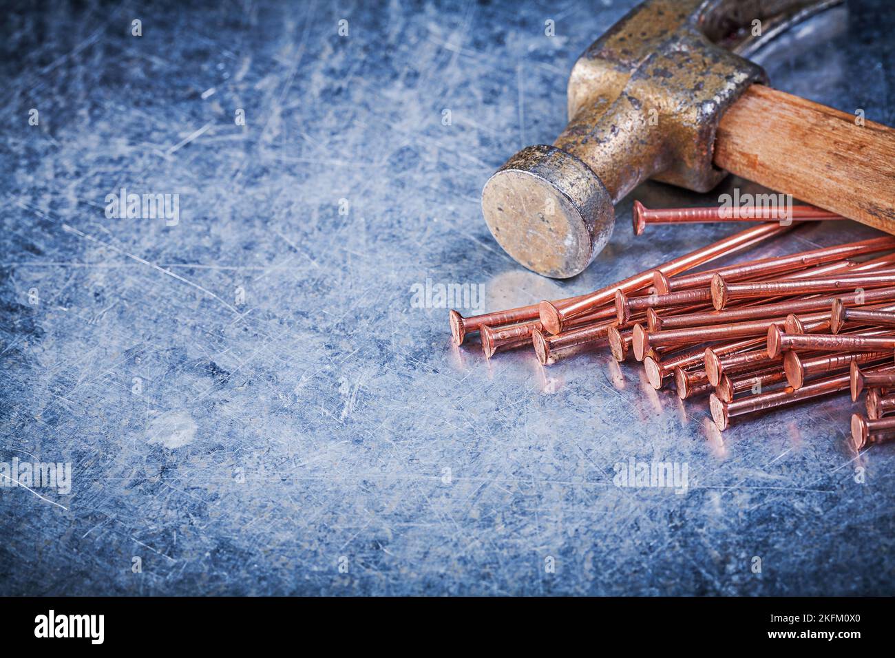 Claw hammer brass nails on metallic background Stock Photo - Alamy