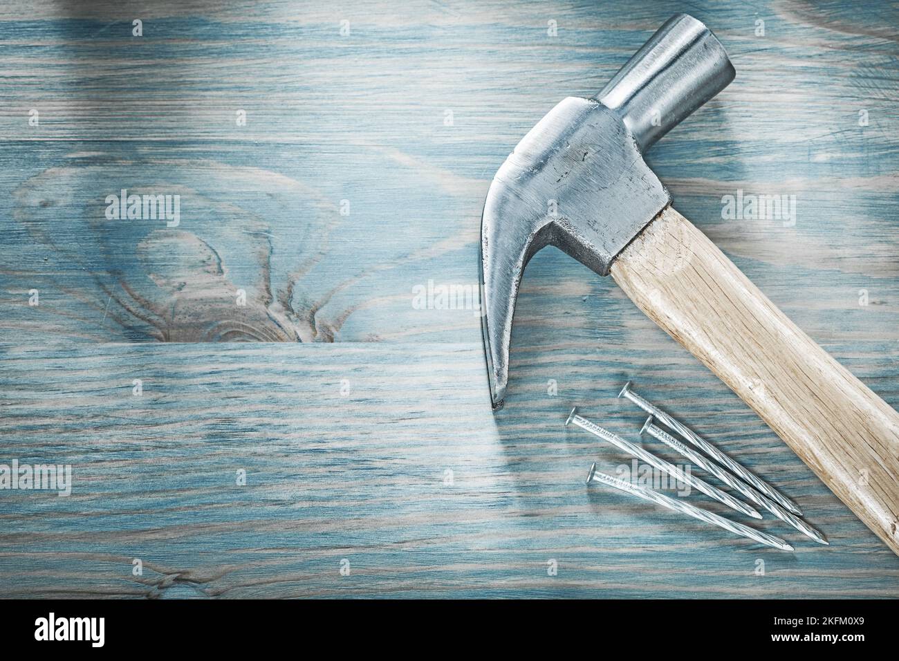 Claw hammer metal nails on wooden board top view construction concept ...