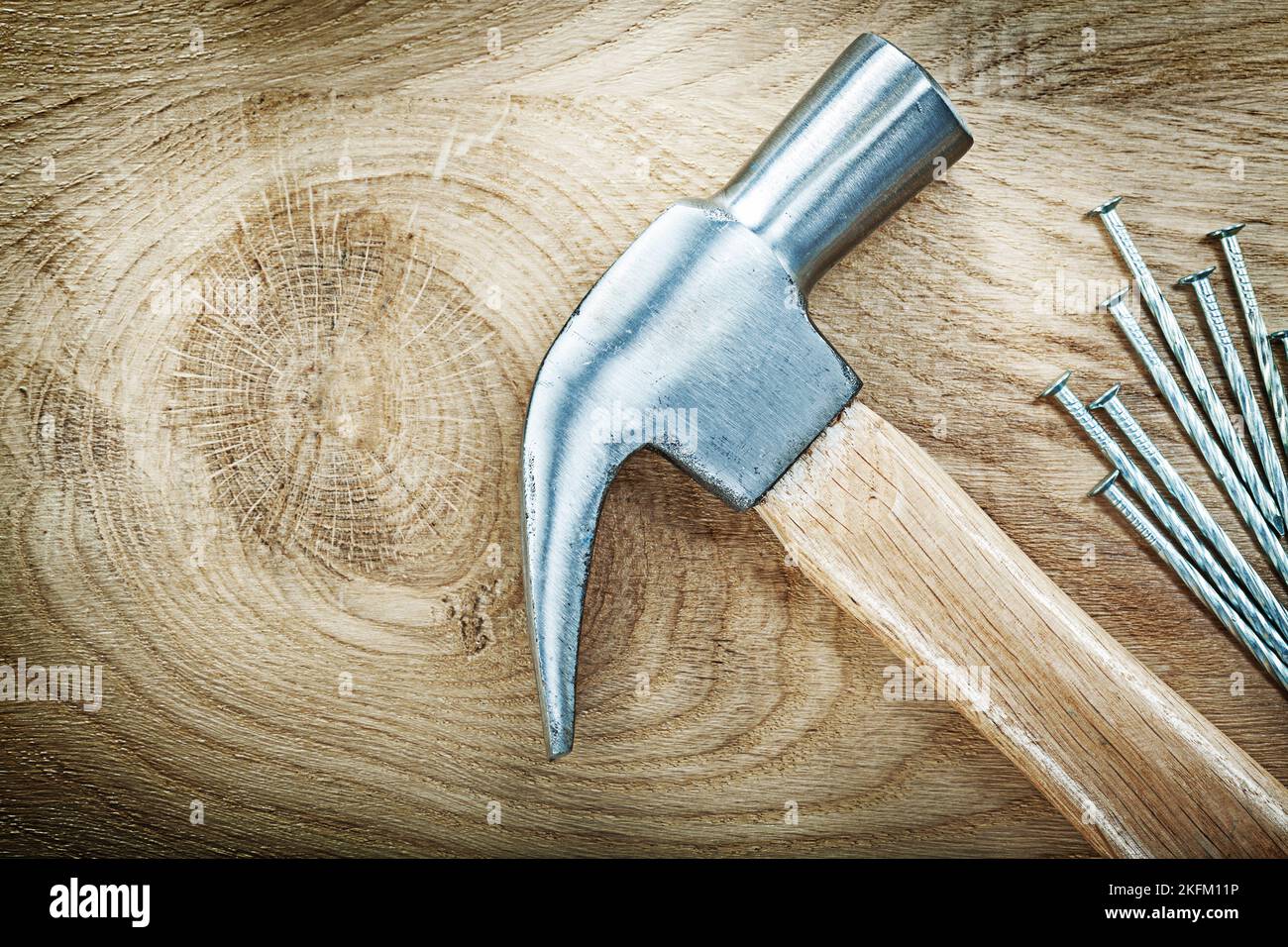 Claw hammer pile of construction nails on wooden board building concept ...