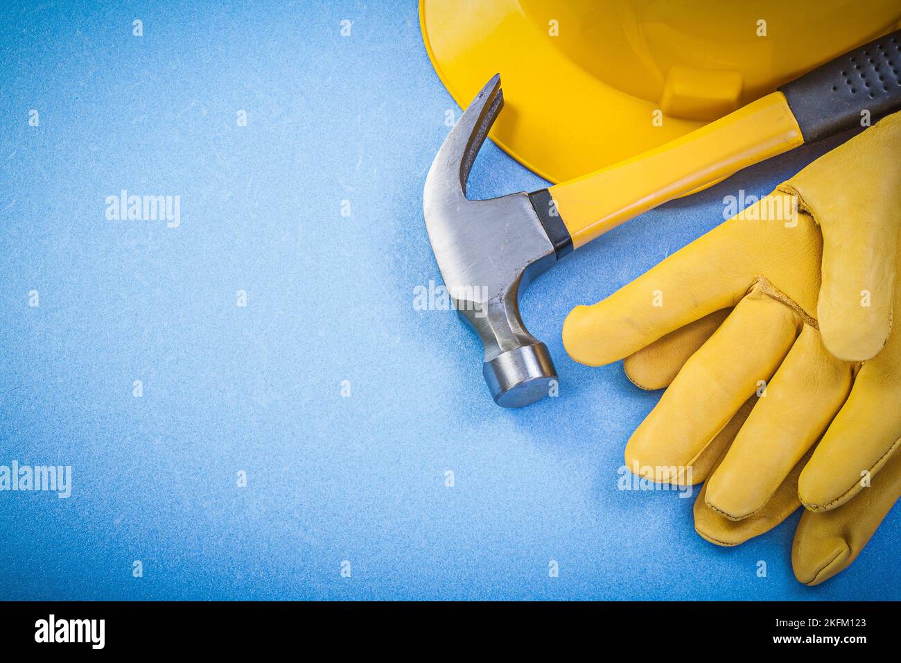 Claw hammer protective gloves hard hat on blue background horizontal ...