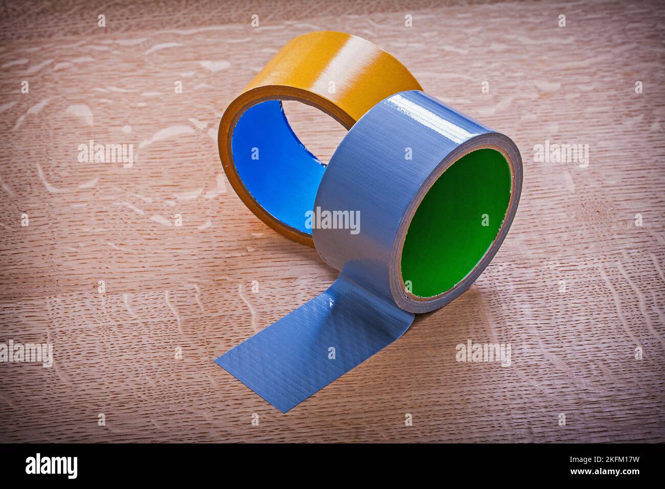 Close up of adhesive tapes on brown wood board maintenance concept ...