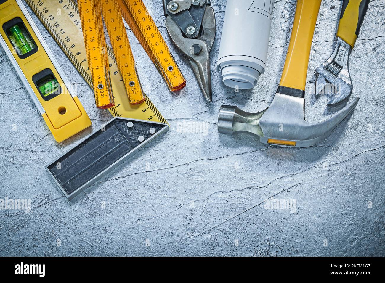 Collection of construction tooling on abstract metallic surface ...