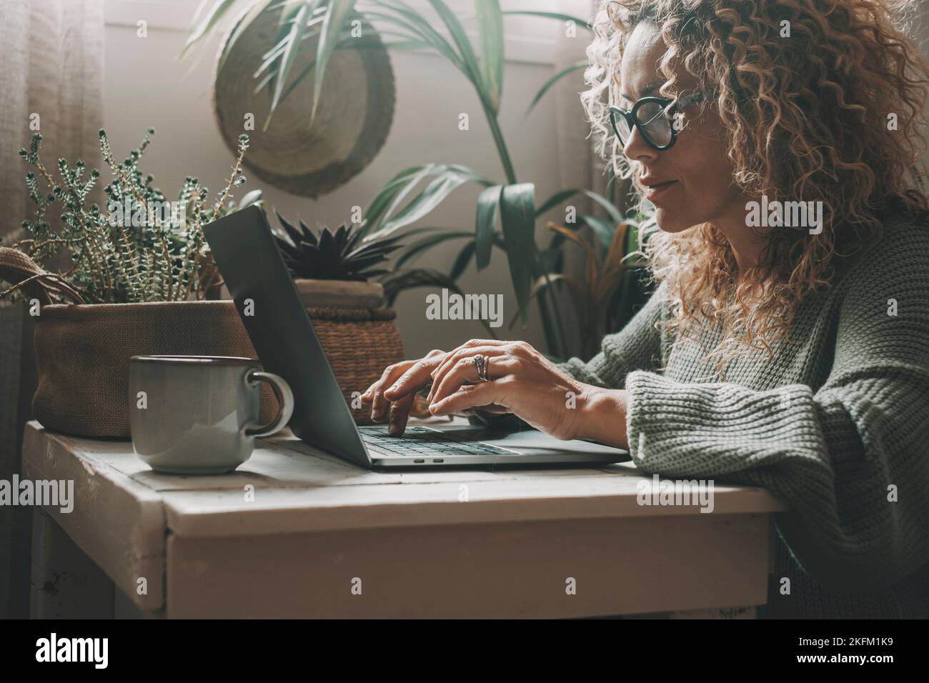One woman at home using laptop in green mood color background and ...