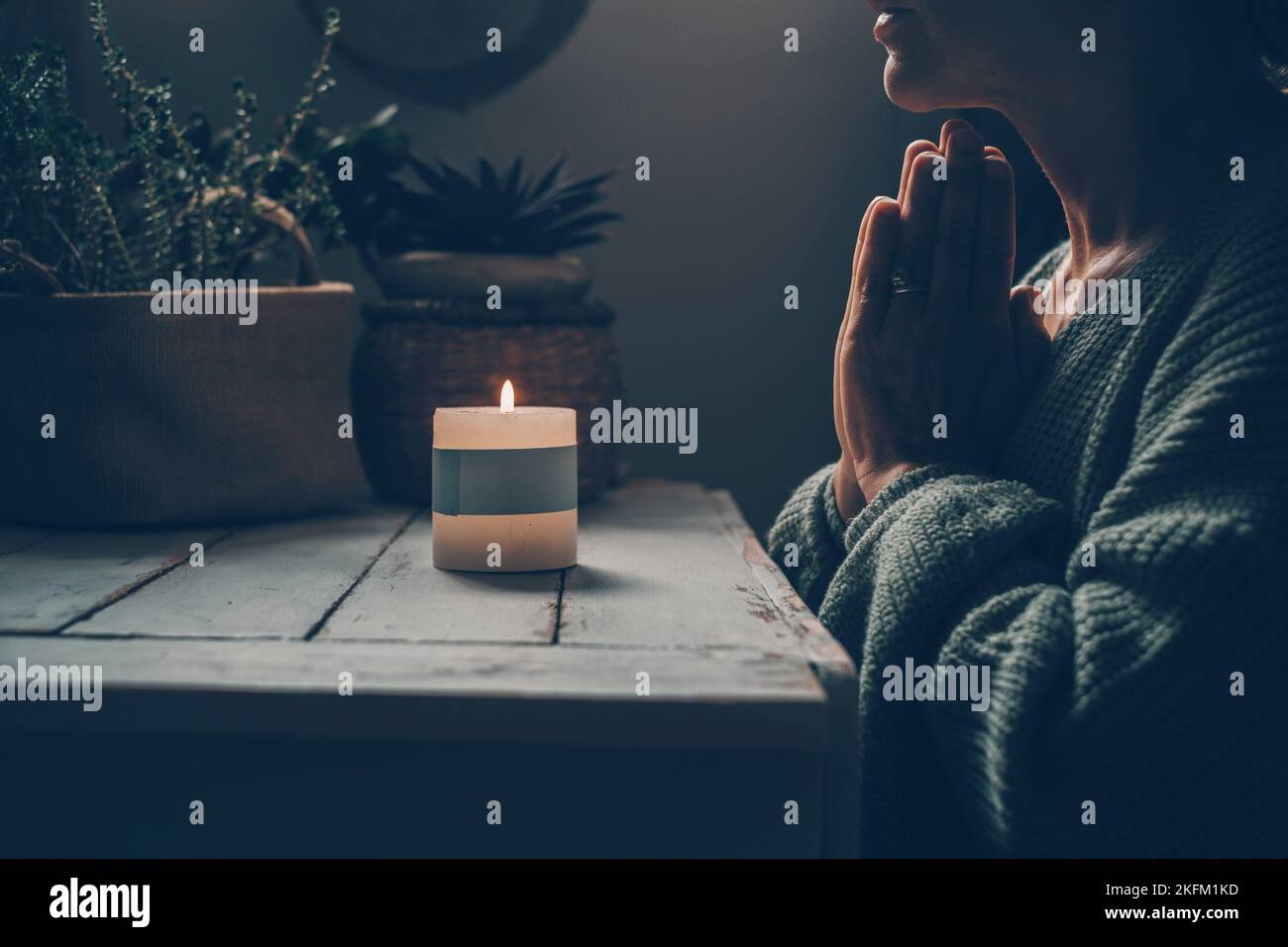 Zen like lifestyle meditation in front of a candle light praying for ...