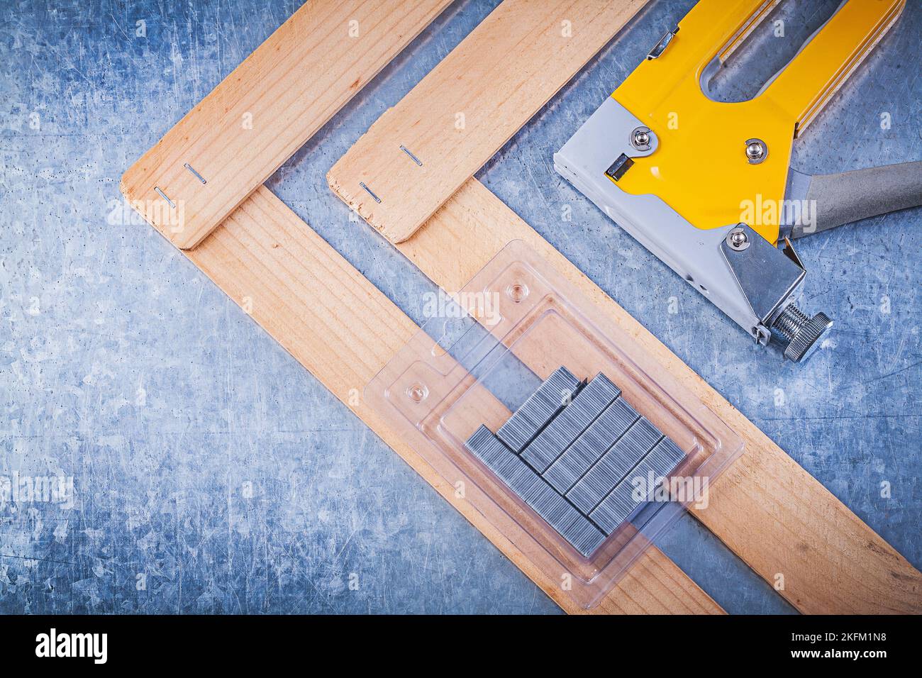 Collection of stapler gun metal staples wooden building board on ...