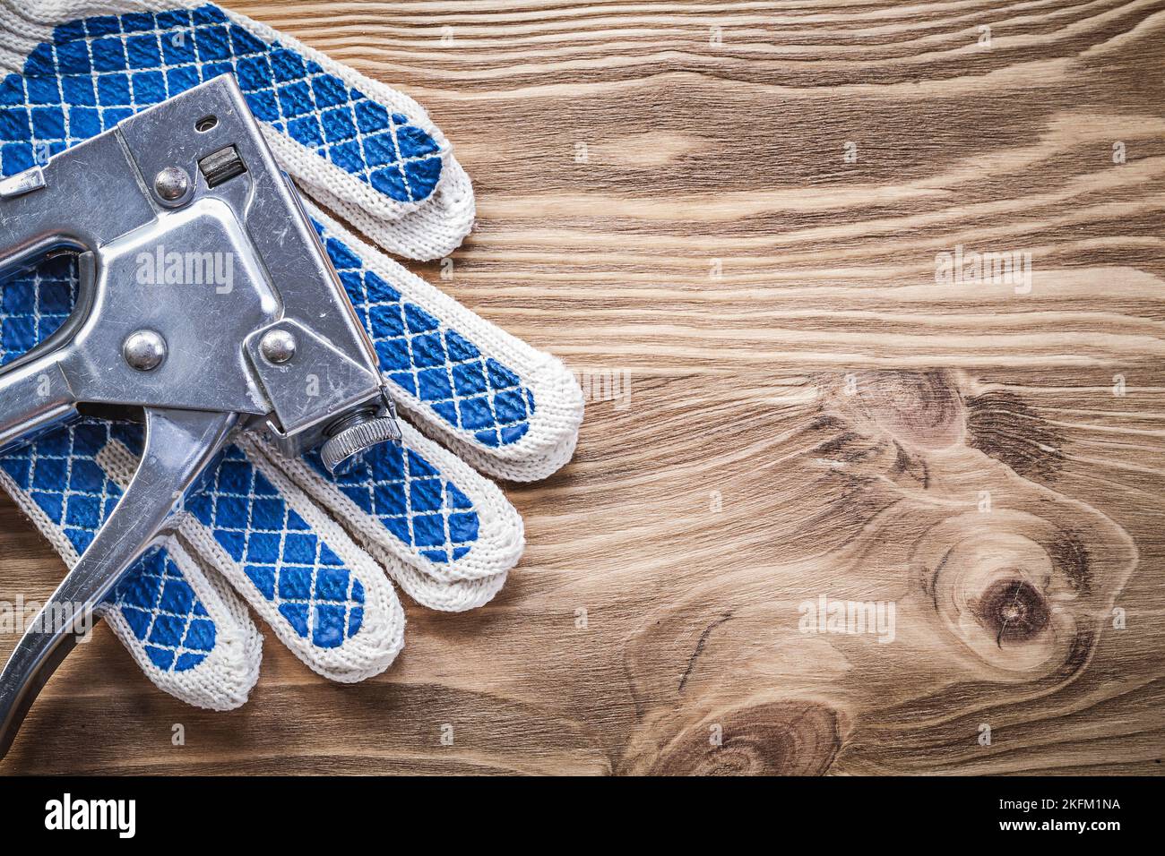 Collection of stapler gun safety gloves on wooden board Stock Photo - Alamy