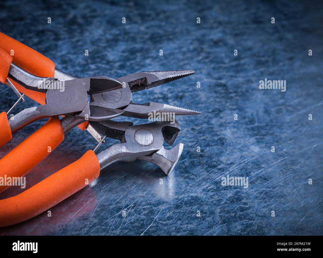 Composition of insulated electric pliers nippers on scratched metallic ...