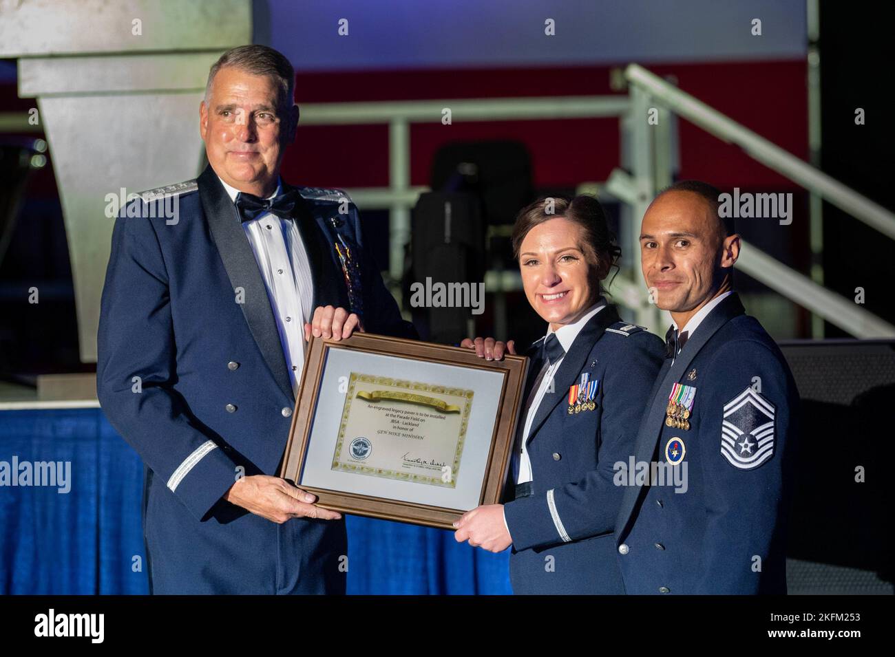 U.S. Air Force Gen. Mike Minihan is given a certificate indicating a ...
