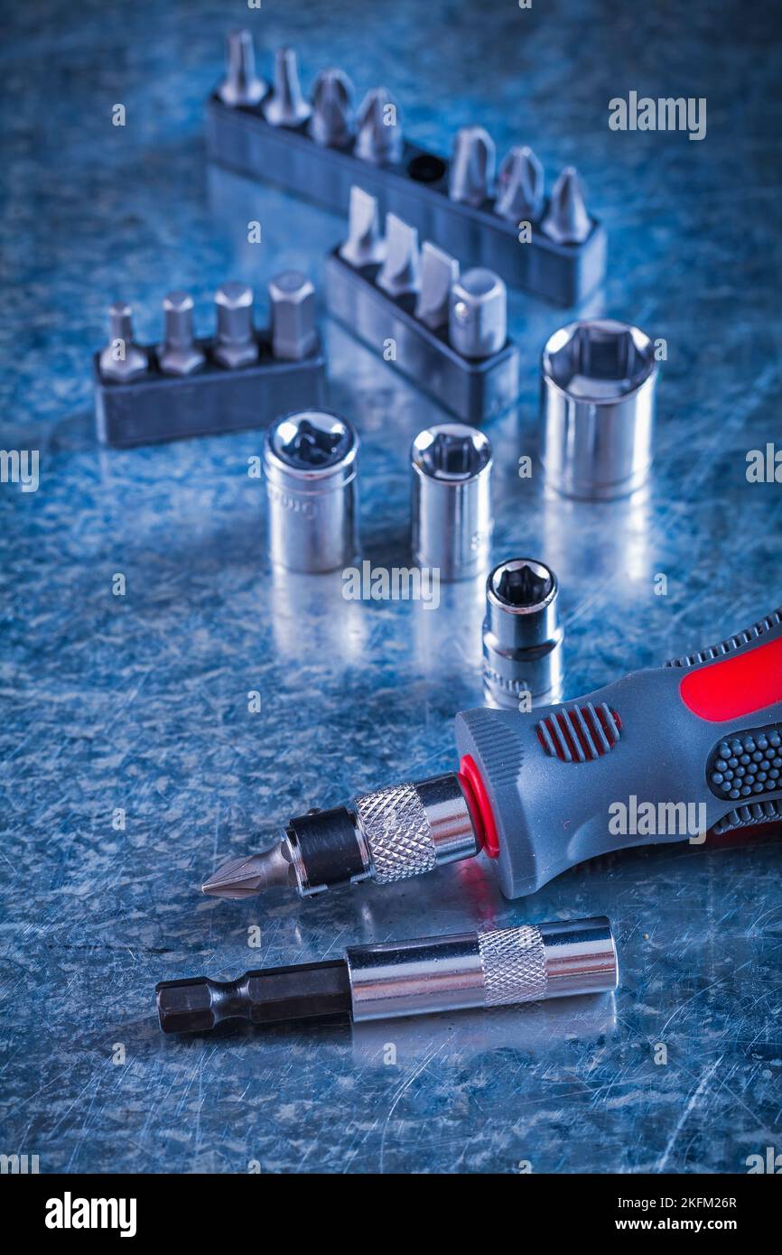 Composition of screwdriver with replaceable heads and bits on scratched ...