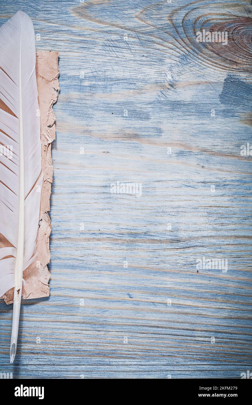 Composition of vintage paper feather on wooden board Stock Photo - Alamy