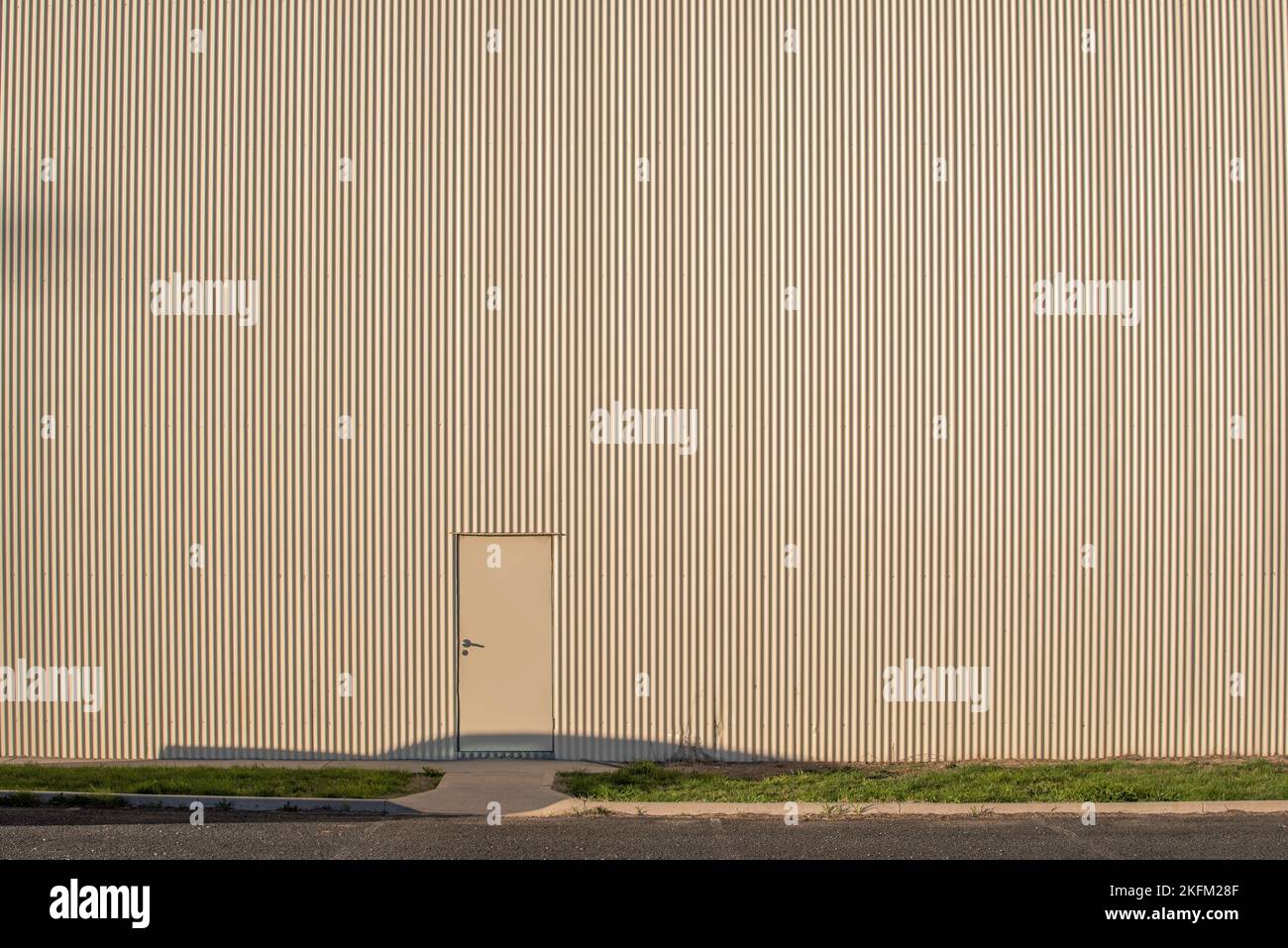 A large Colourbond steel (metal) building wall with a single door entry ...