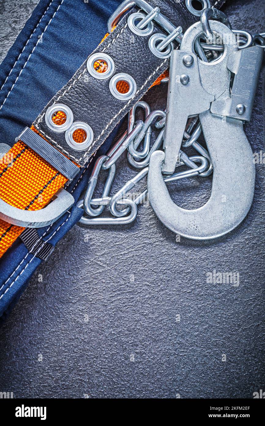 Construction harness with metal chain on black background maintenance ...