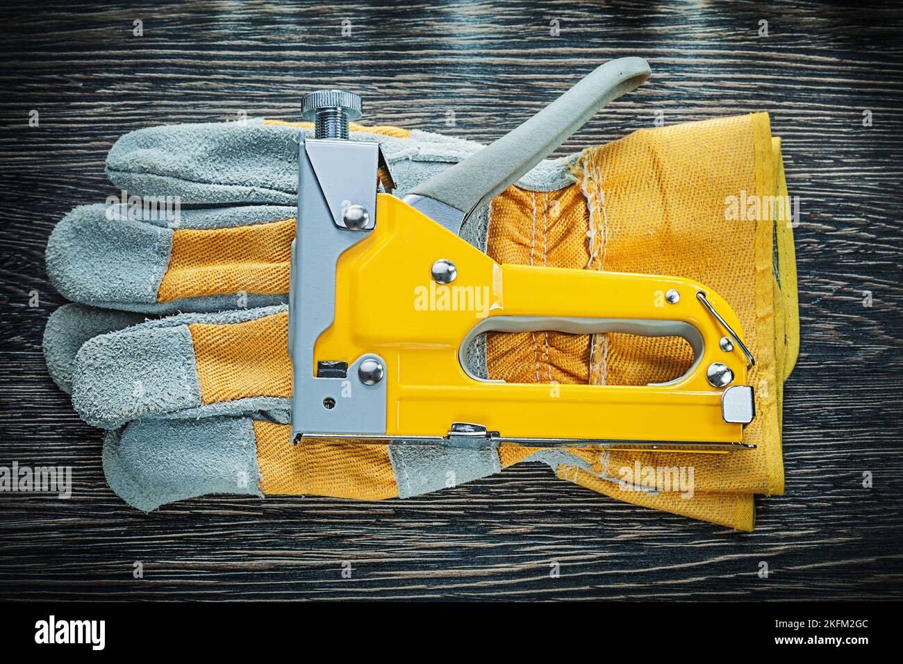 Construction staple gun pair of safety gloves Stock Photo - Alamy
