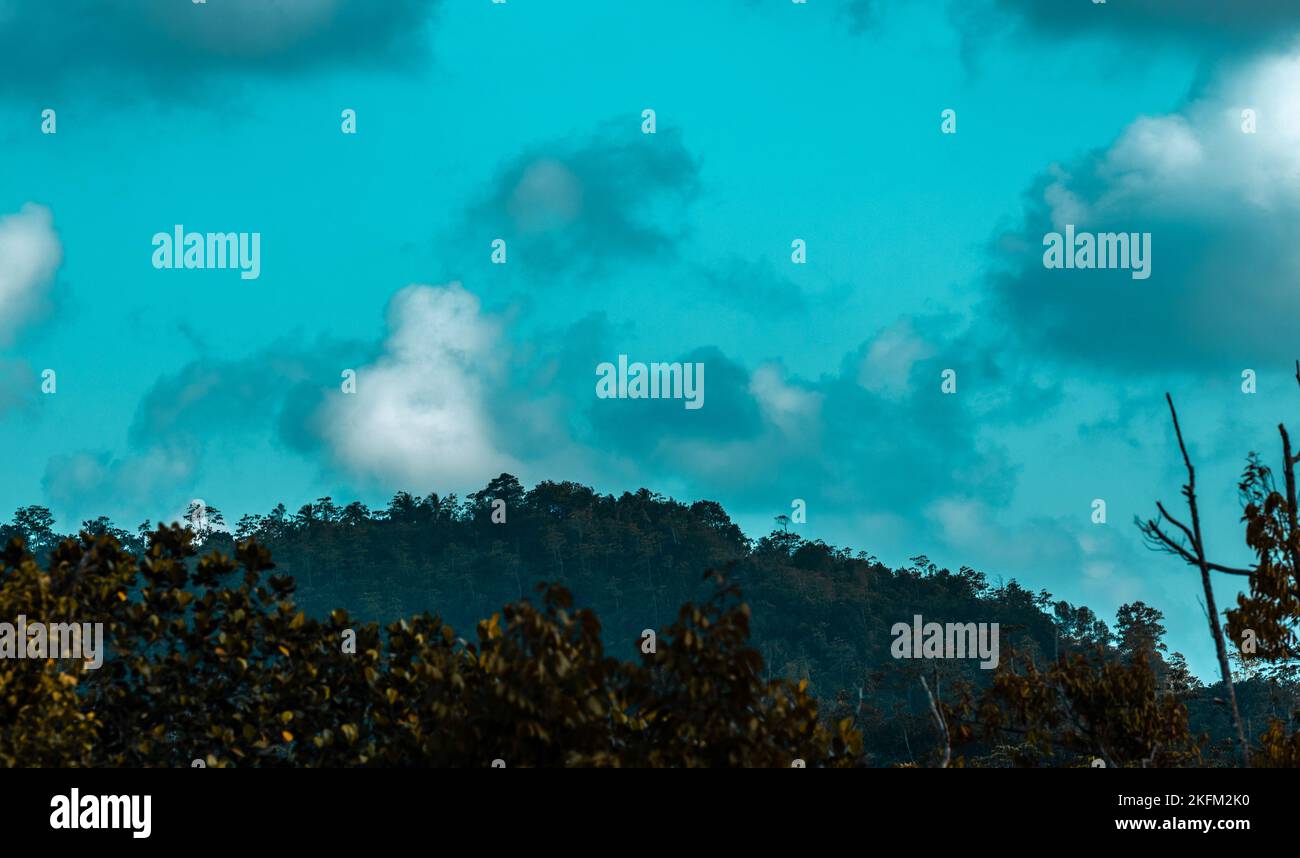 Nice teal sky landscape with white clouds over mountain in a morning ...
