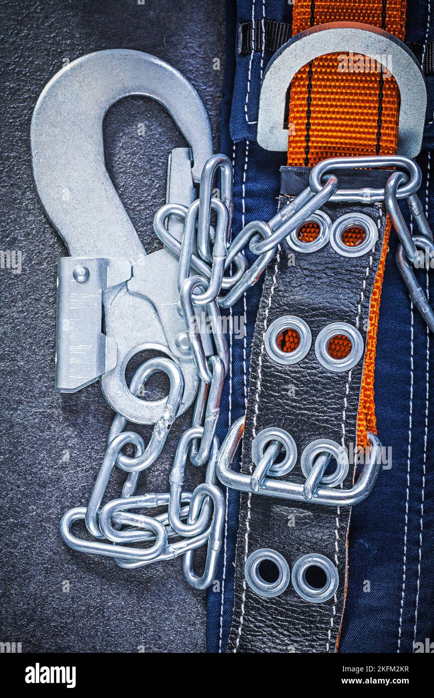 Construction safety strap with metal chain on black background ...