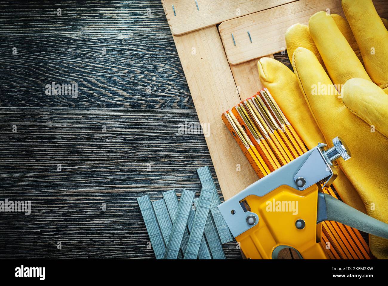 Construction stapler staples wooden meter planks safety gloves Stock ...