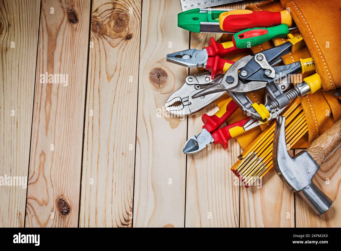 construction tools in leather toolbelt on wooden boards Stock Photo - Alamy
