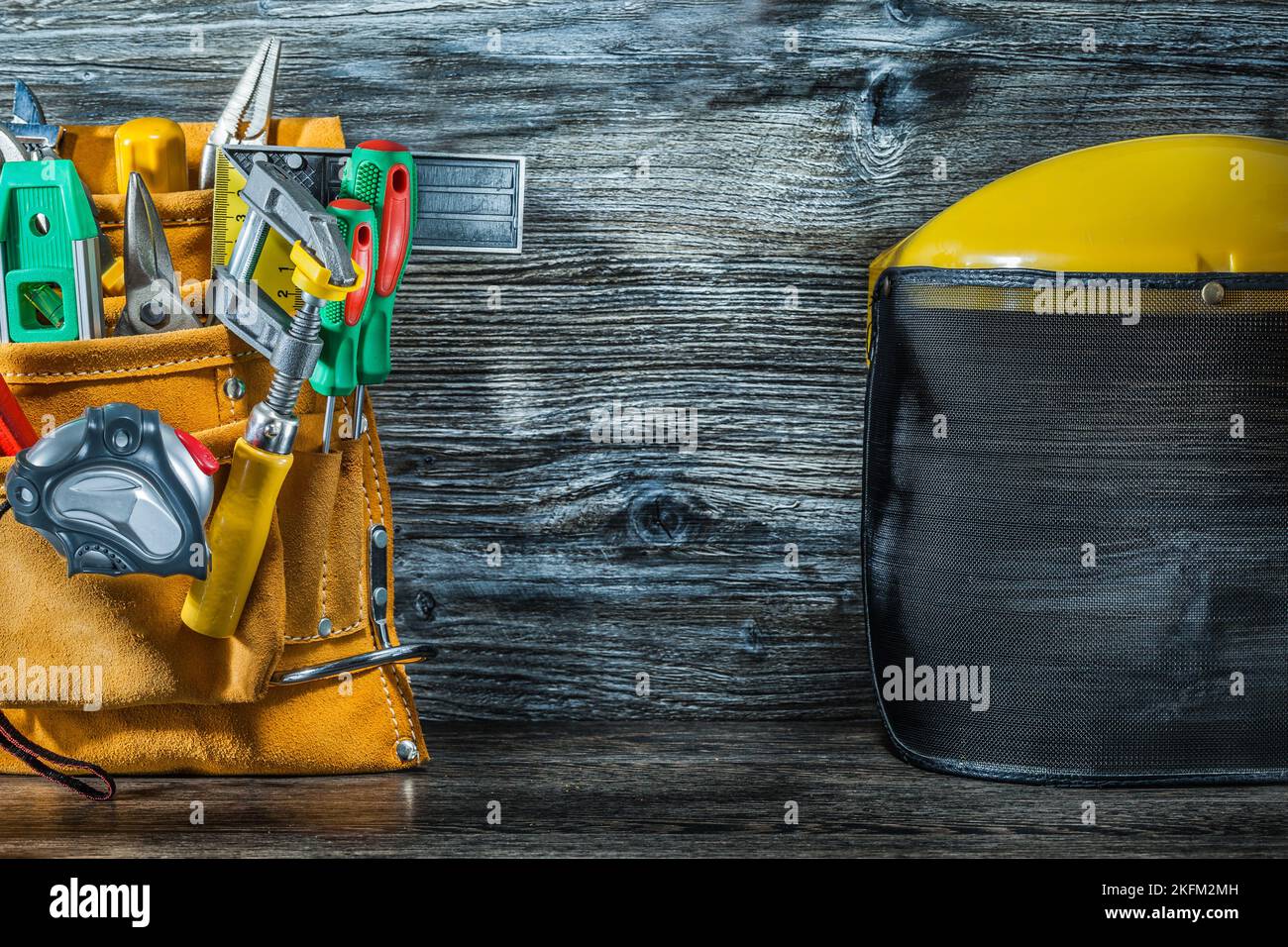 construction tools in toolbelt and safety mask on vintage wood Stock ...