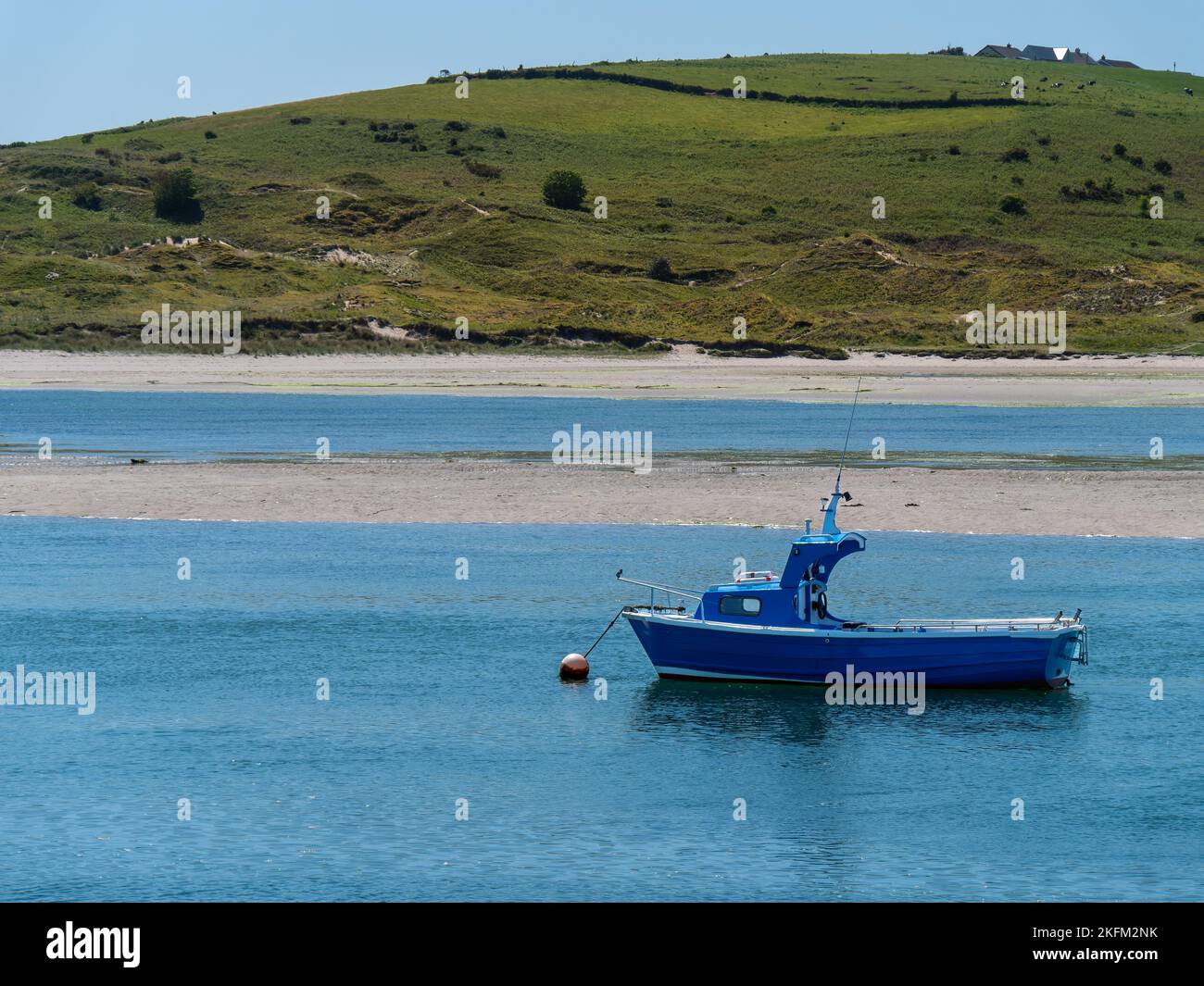 One small boat is anchored in the bay at low tide, a seaside landscape ...