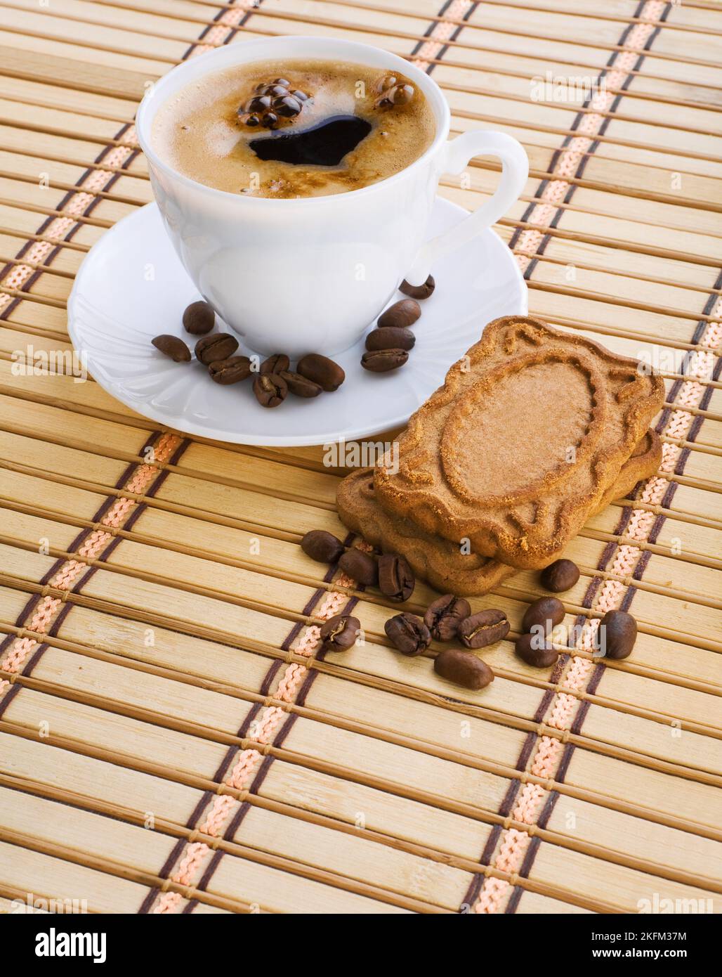 cup of capuchino with coffee beans and cookie on a mat Stock Photo - Alamy