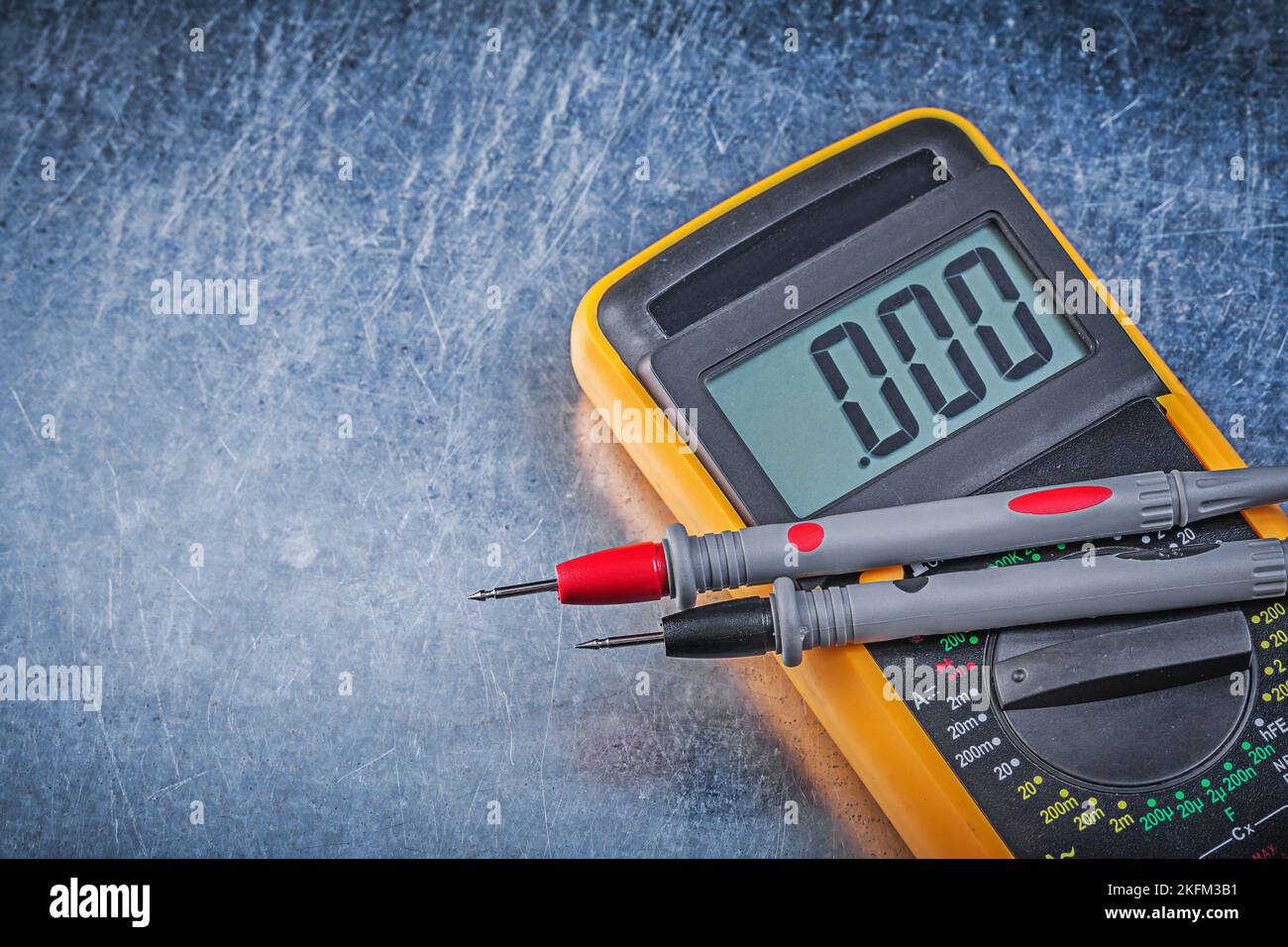 Digital electric tester wires current probe on scratched metallic ...