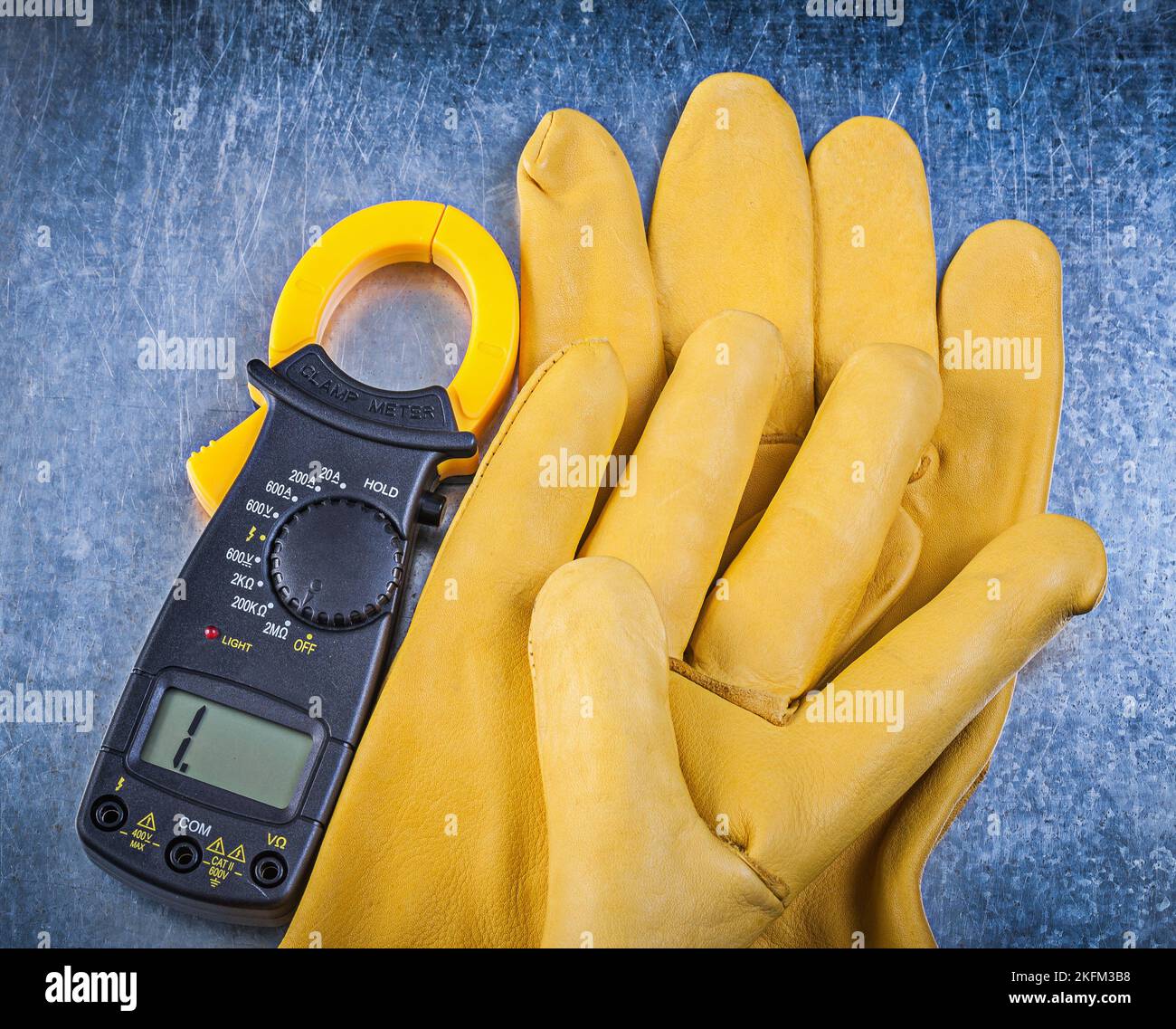 Digital amperemeter safety gloves on metallic background Stock Photo ...