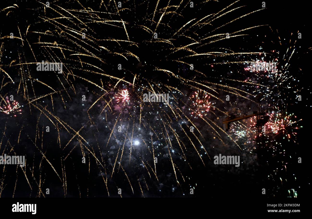 colorful fireworks at night with shadows of a construction site and ...