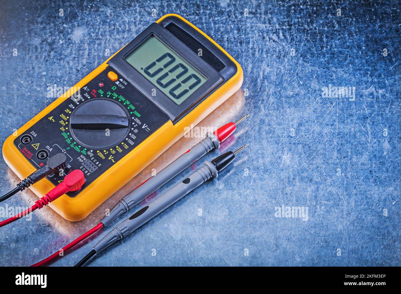 Digital electrical tester on metallic surface directly above ...