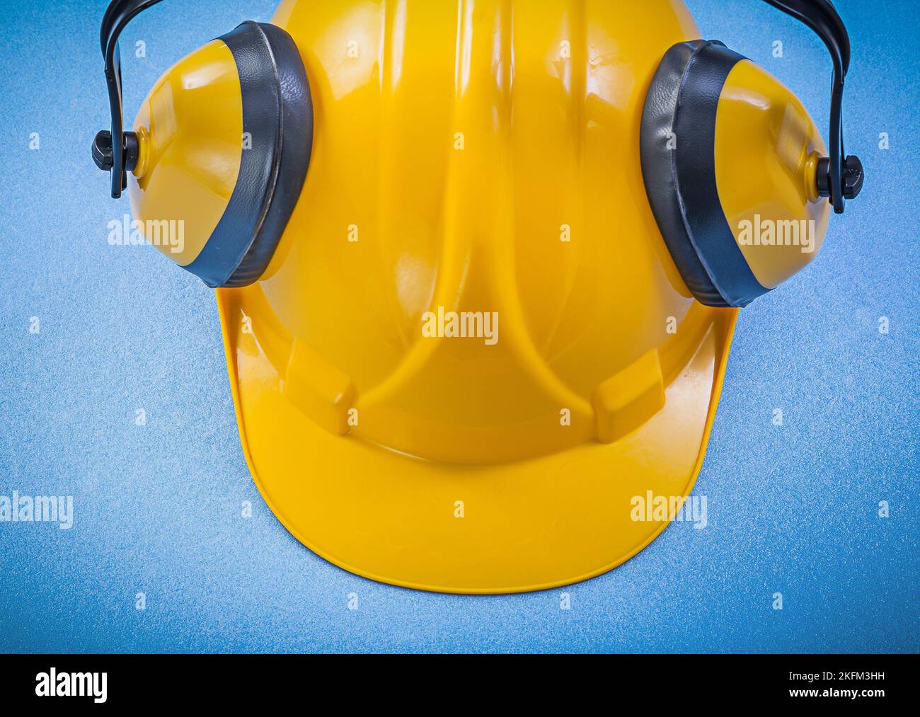 Ear muffs hard hat on blue background construction concept Stock Photo ...