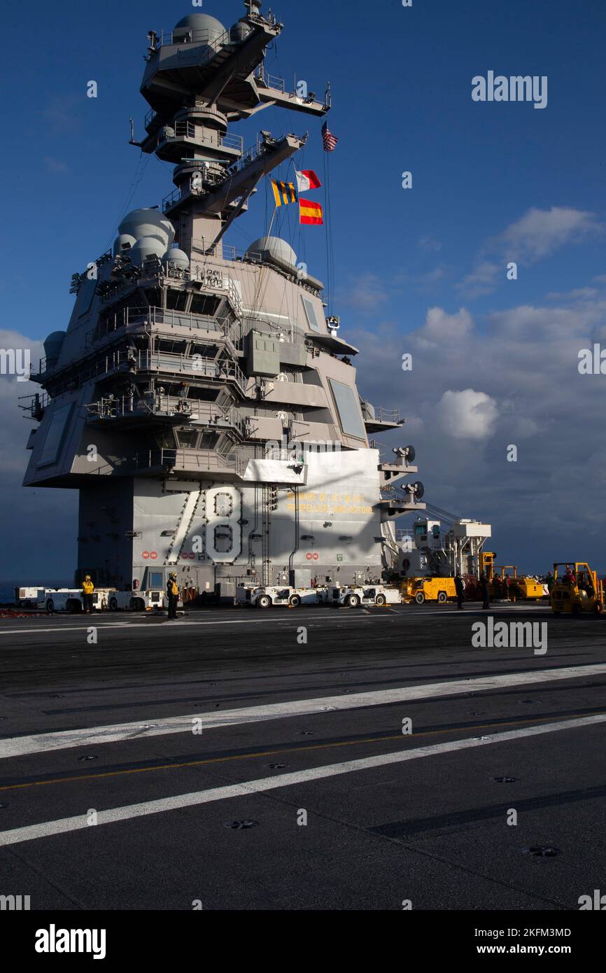 The shadow of an MH-60S Nighthawk attached to the "Tridents" of ...