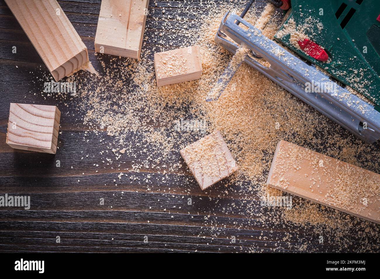 Electric jigsaw sawdust and wooden planks on vintage wood board top ...